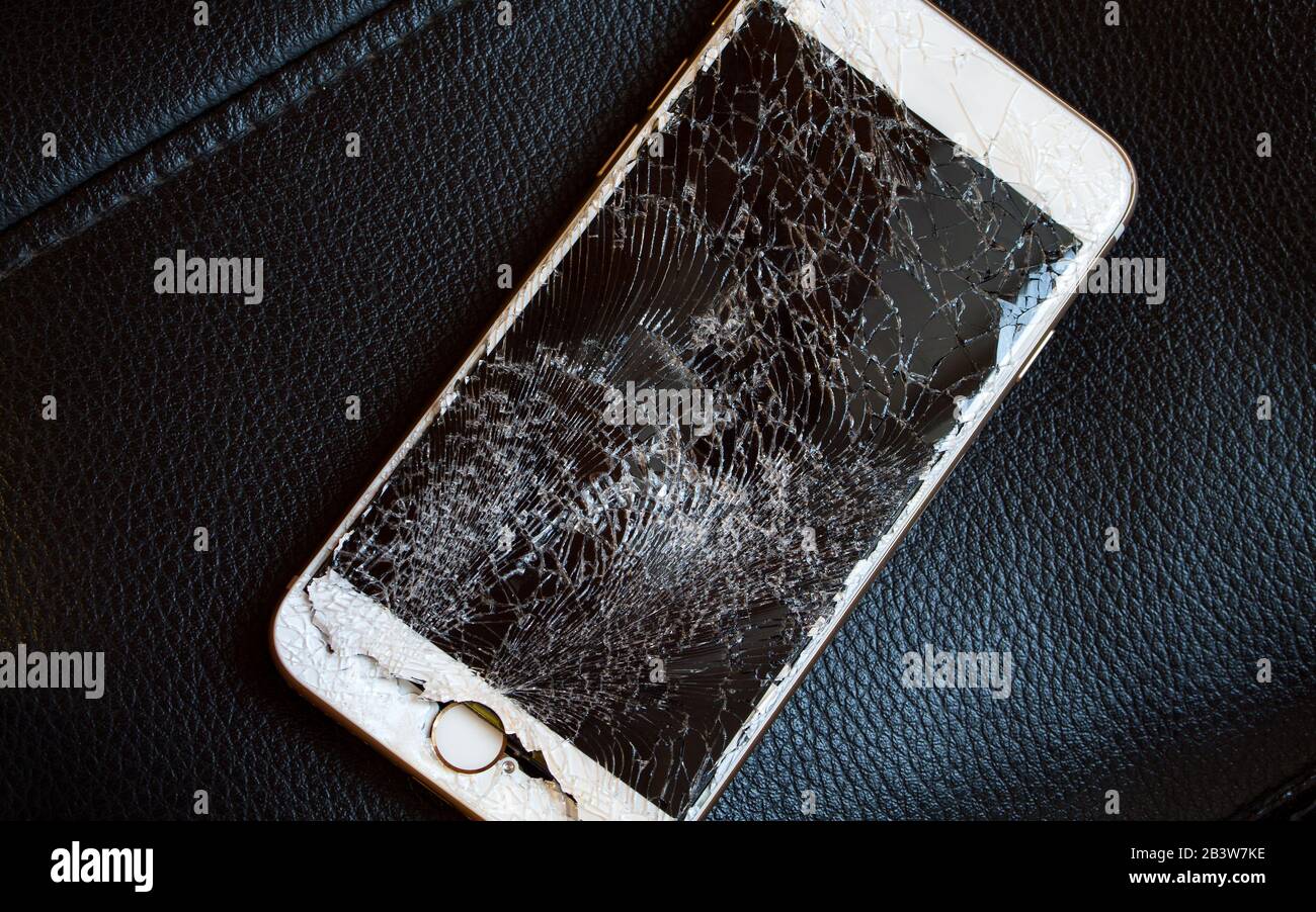 Modern smartphone with highly broken screen on black background Stock ...