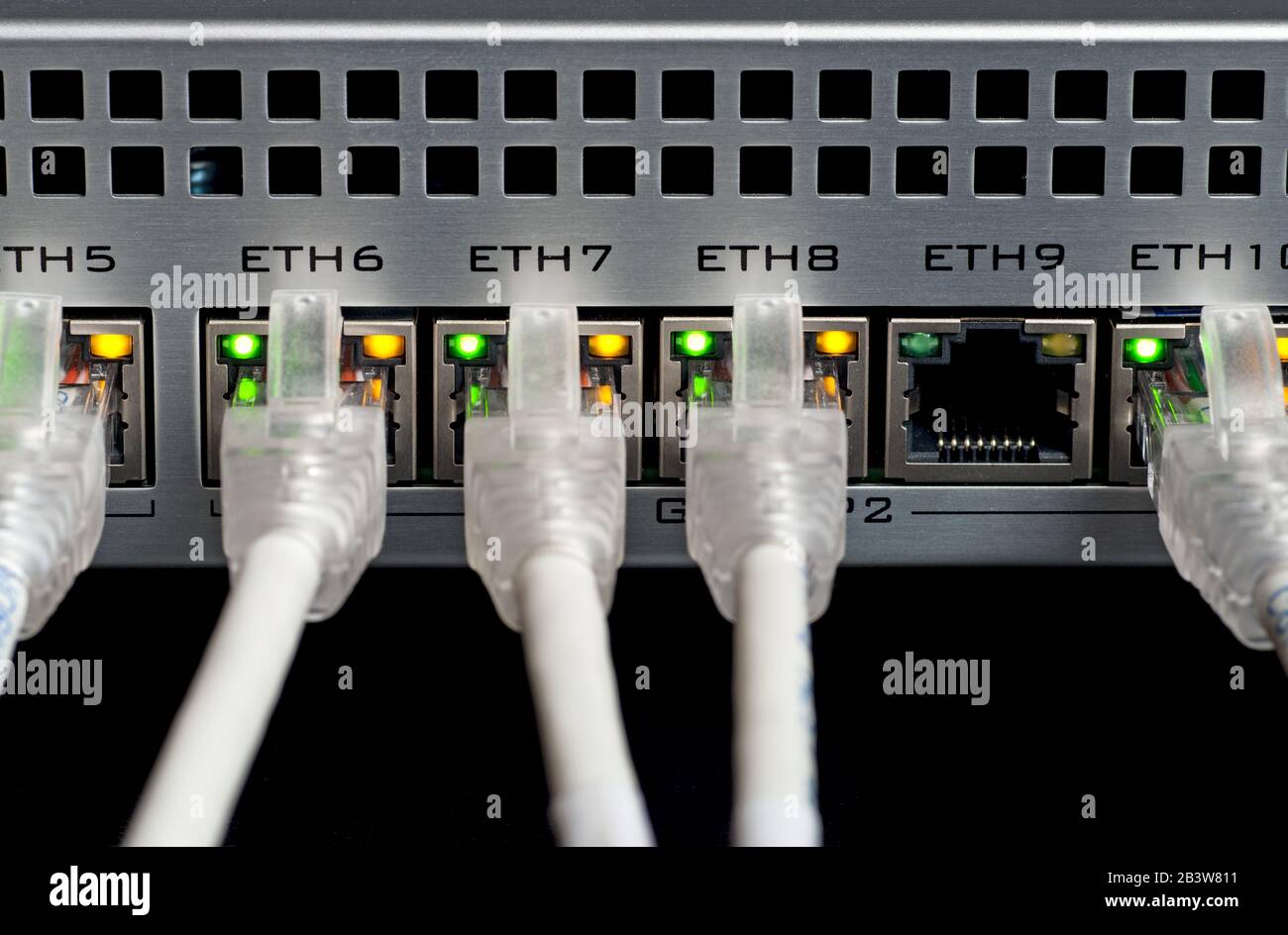 White network cables connected to a switch. Selective focus Stock Photo ...