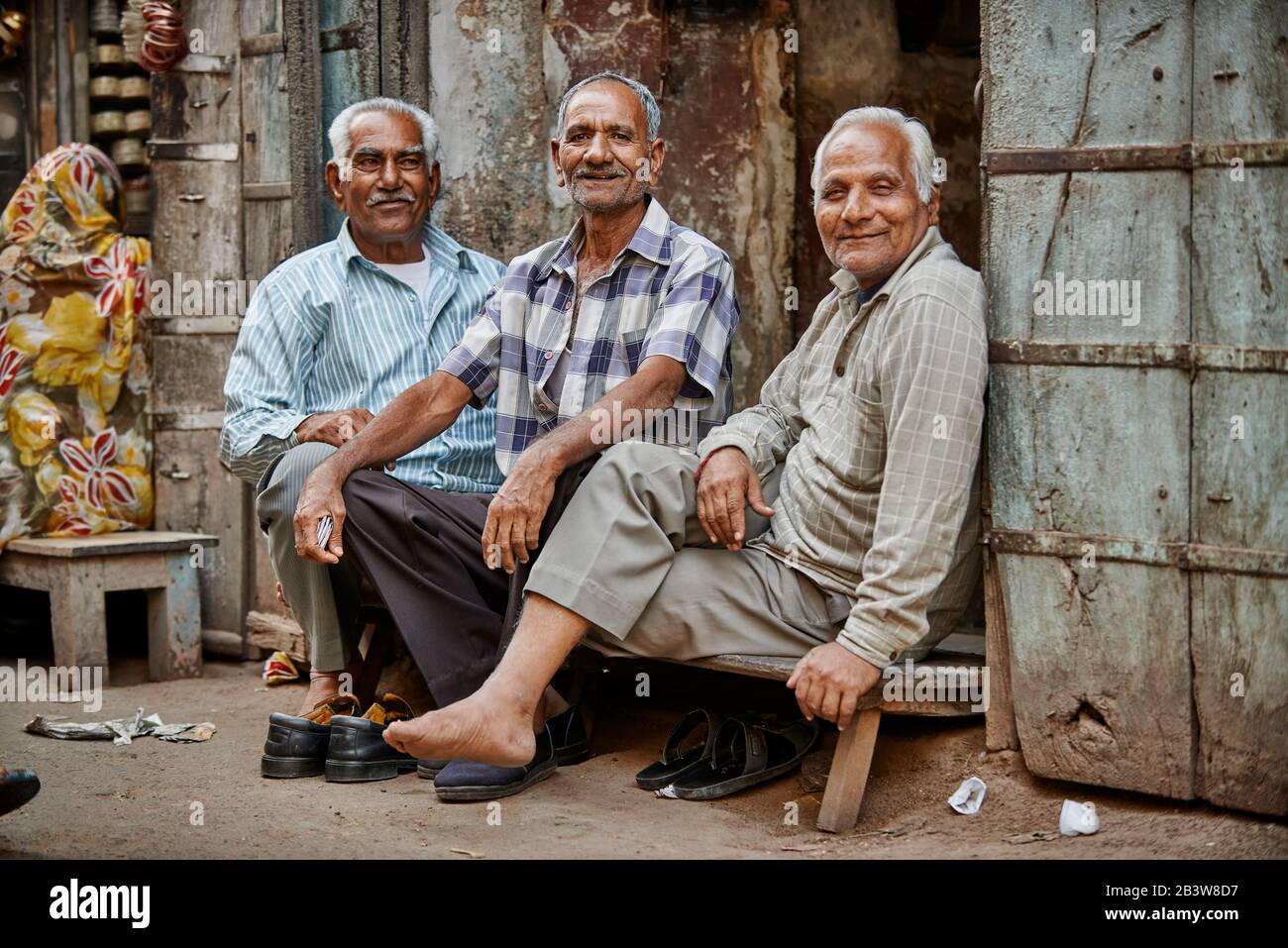 Portrait of three Indian men sitting at the road, Bikaner, Rajasthan ...