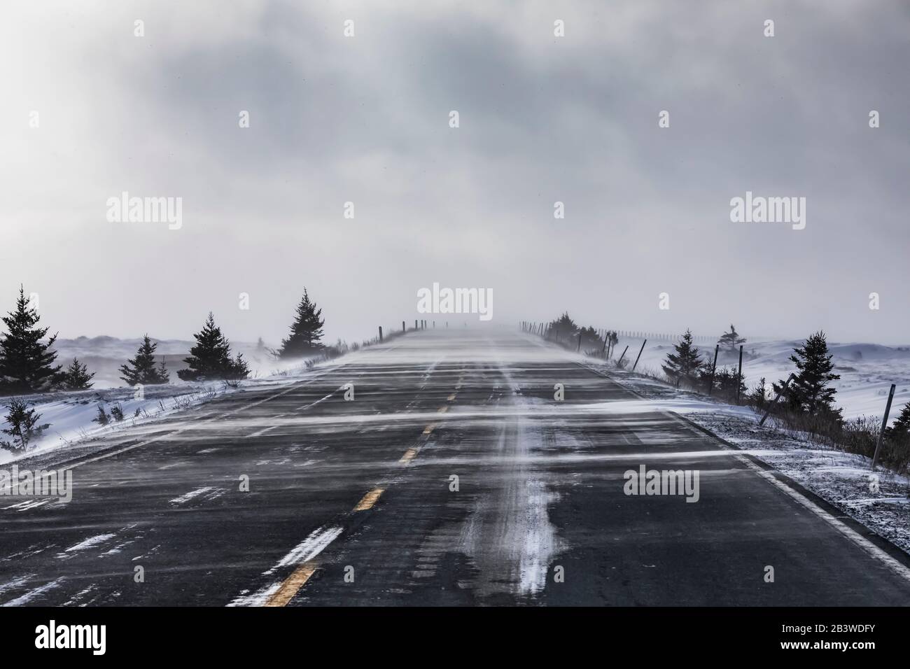 Route 10 highway with snow blowing across the road on a stormy winter ...