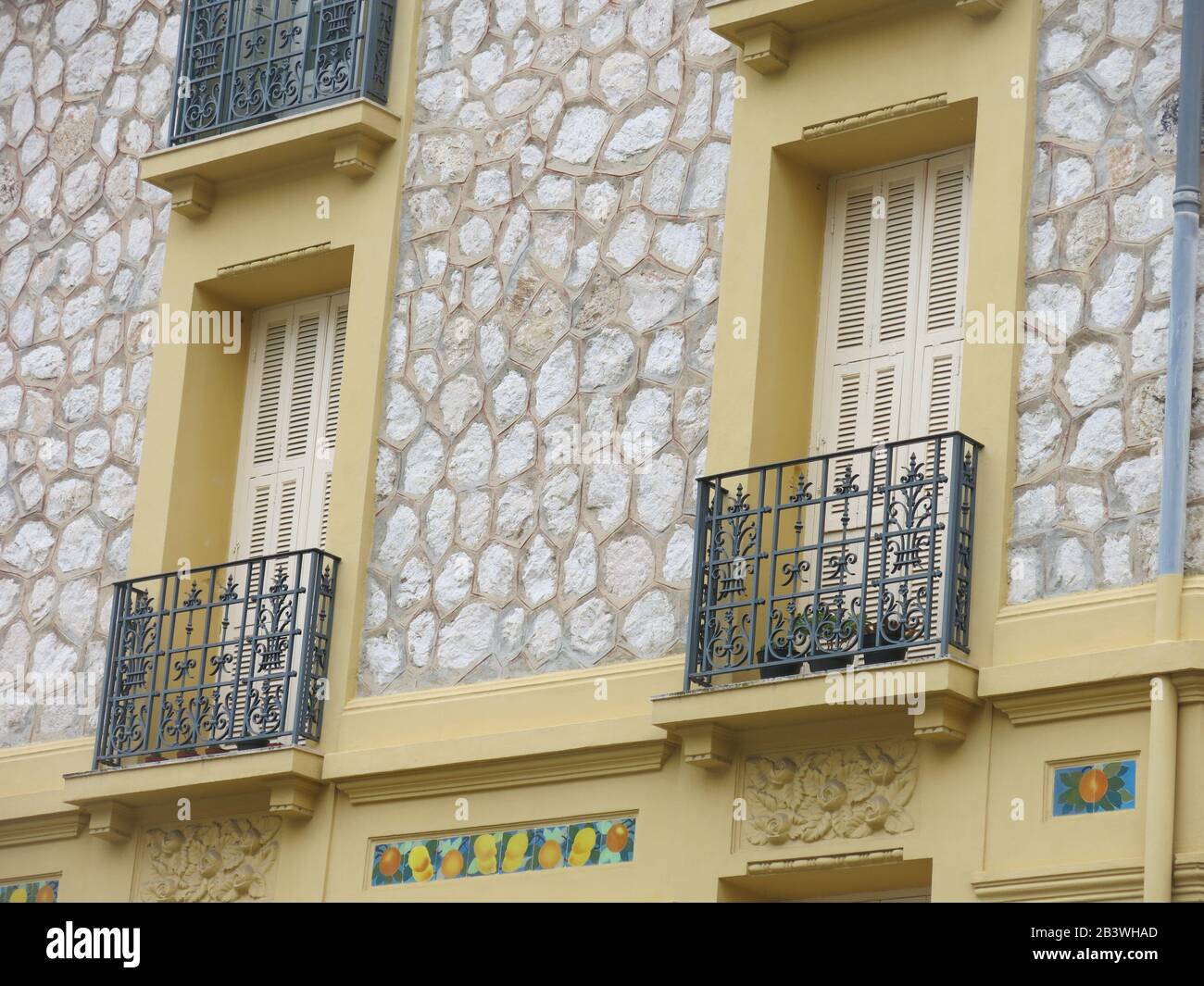 A Mediterranean style of architecture with wooden shutters at all the ...