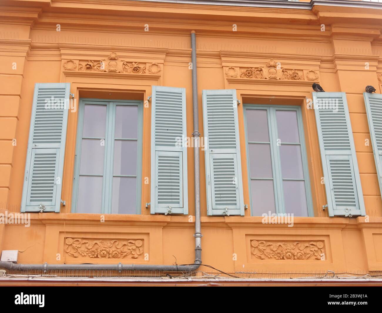 A Mediterranean style of architecture with wooden shutters at all the ...