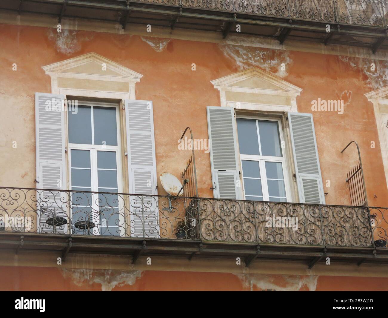 A Mediterranean style of architecture with wooden shutters at all the ...