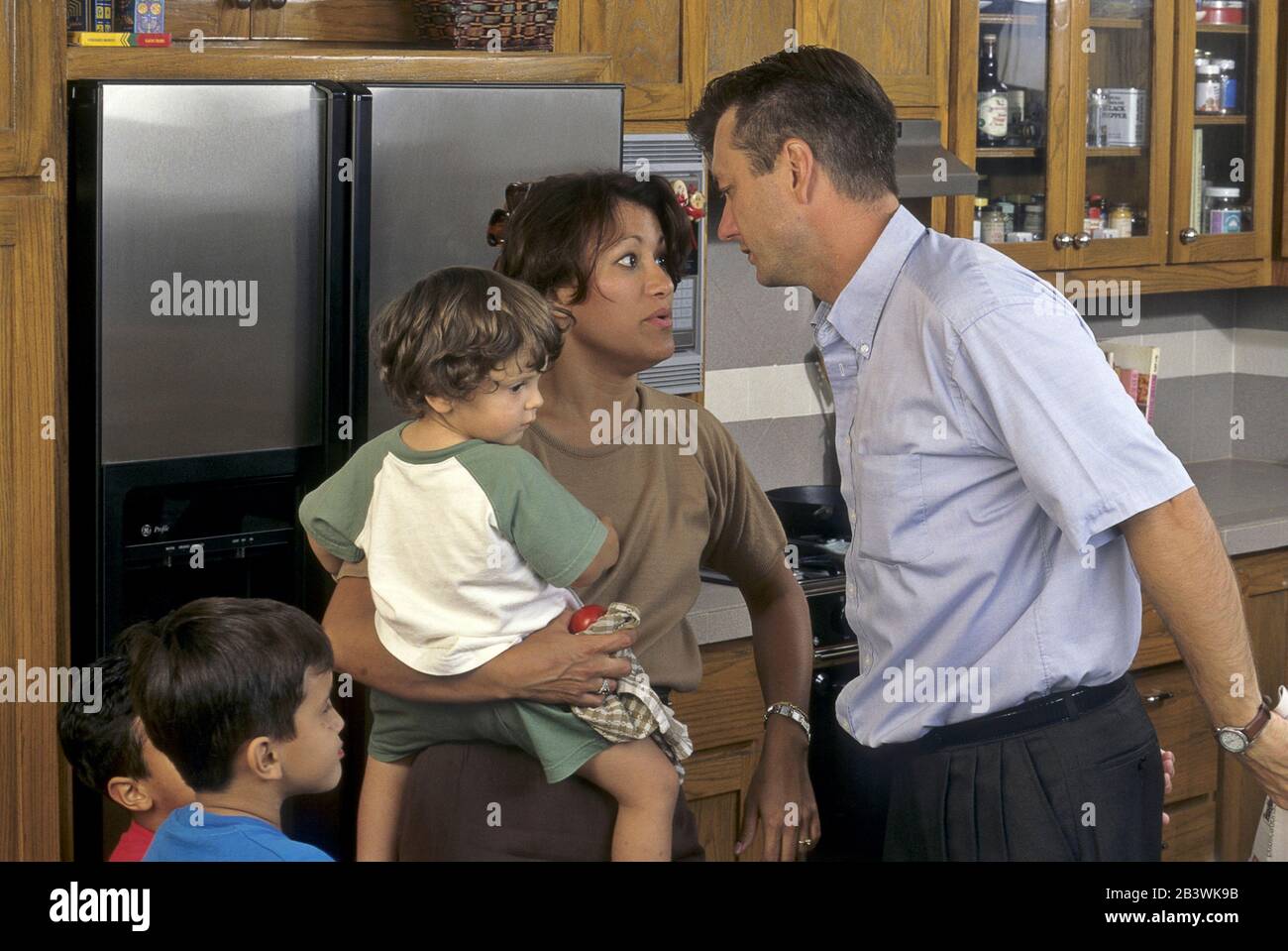 Married couple arguing in front of their kids at home. MR ©Bob ...