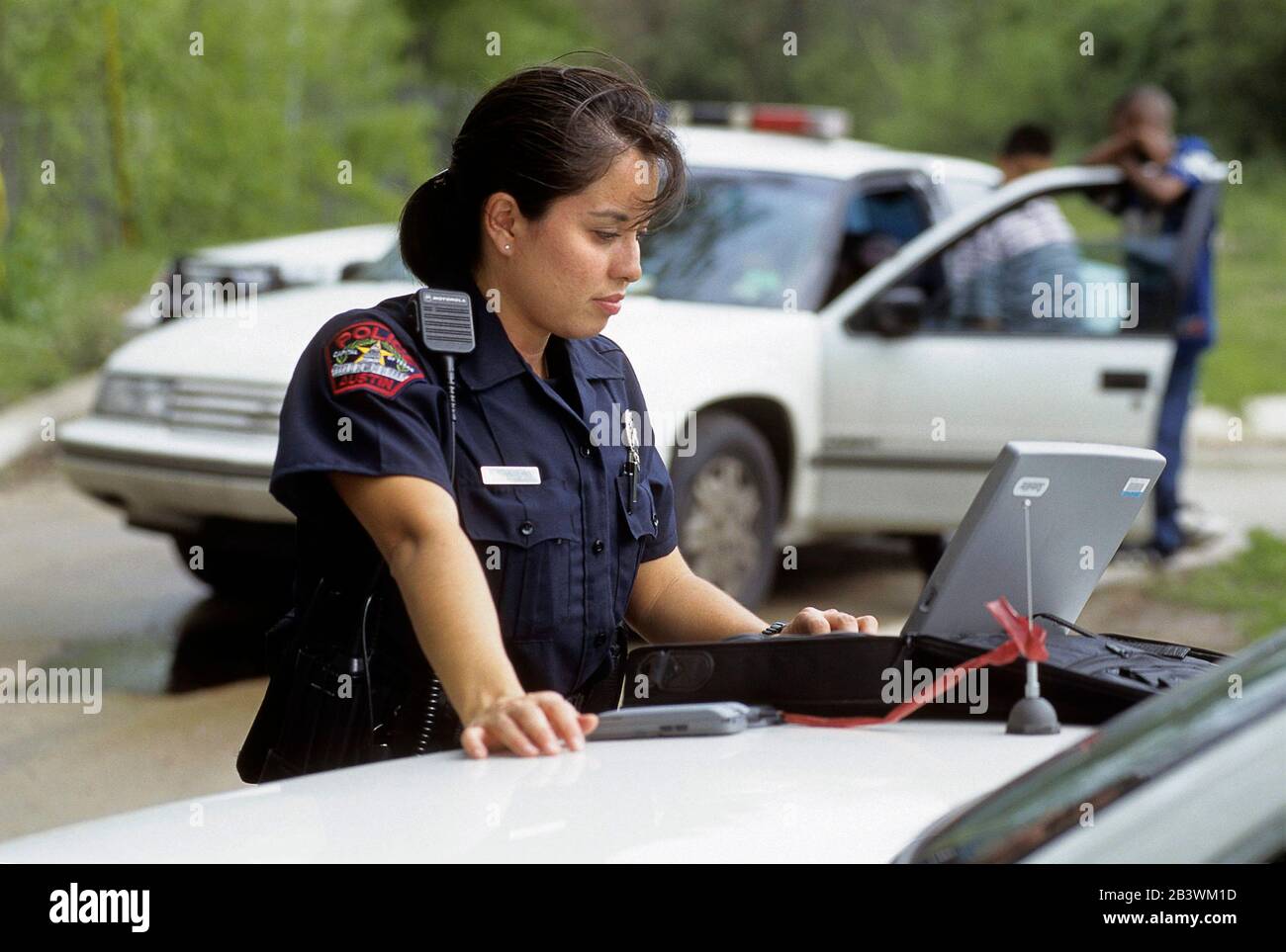 Austin Texas USA: Hispanic female police officer using a laptop ...