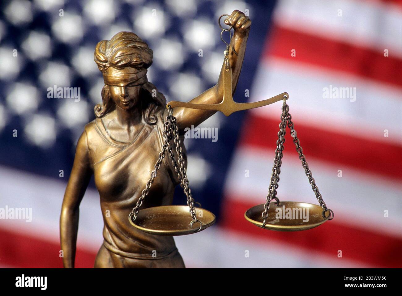 Bronze Scales of Justice with American flag in background. ©Bob ...