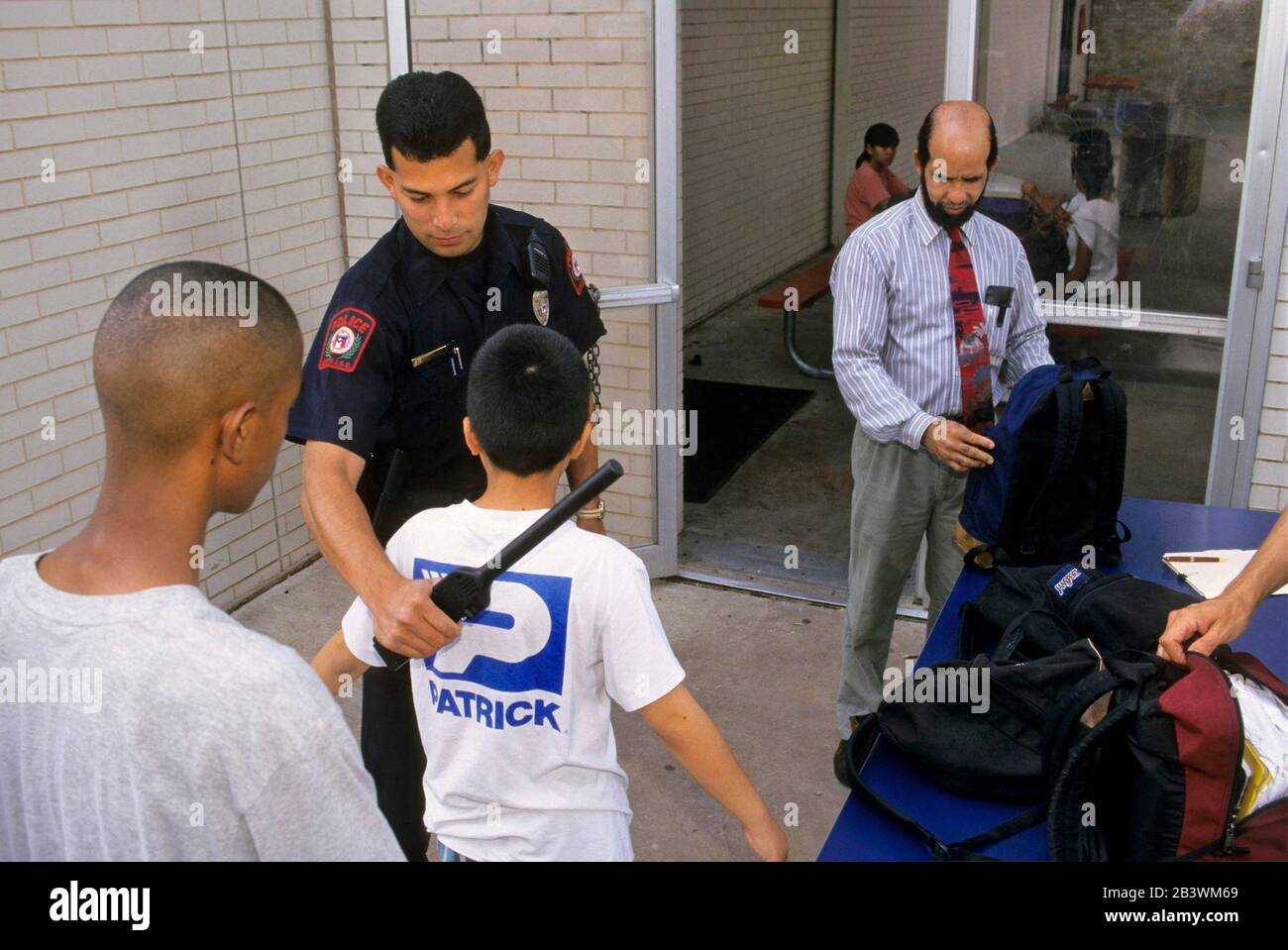 Austin Texas USA, circa 1997: A school police officer uses a metal ...