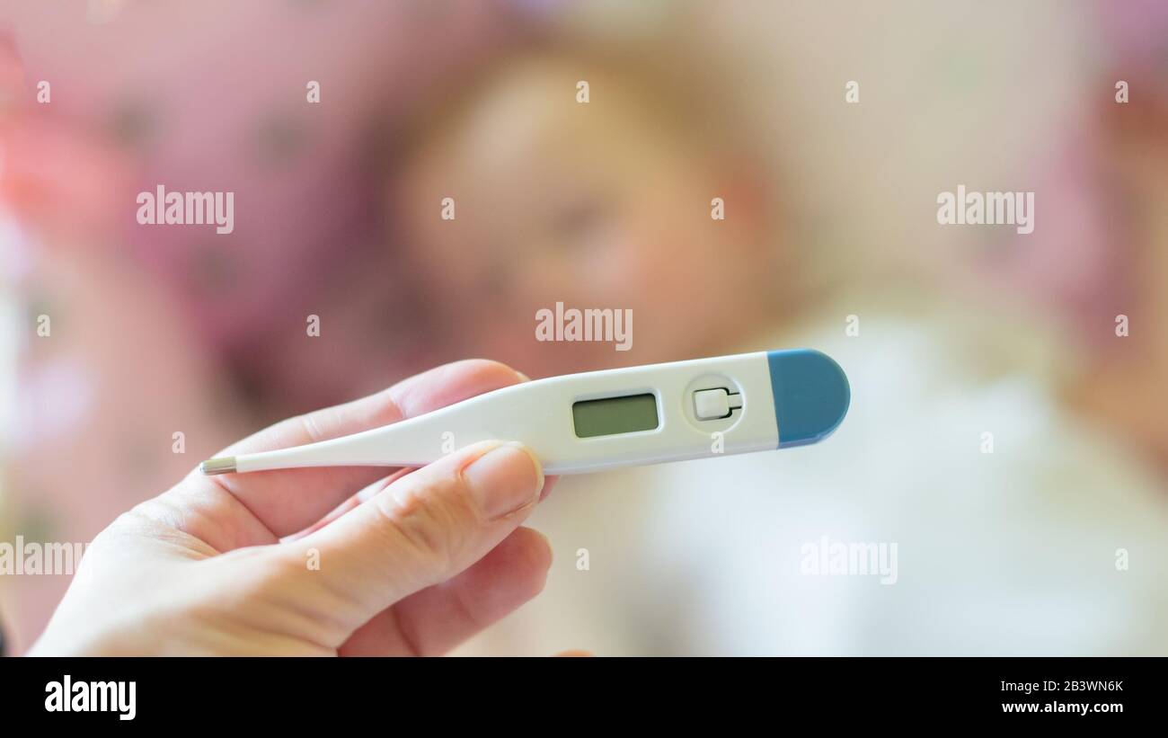 Close-up medical thermometer, Parent measuring temperature of ill kid ...
