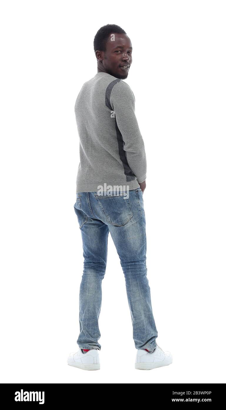 rear view. smiling young man looking back at the camera Stock Photo - Alamy