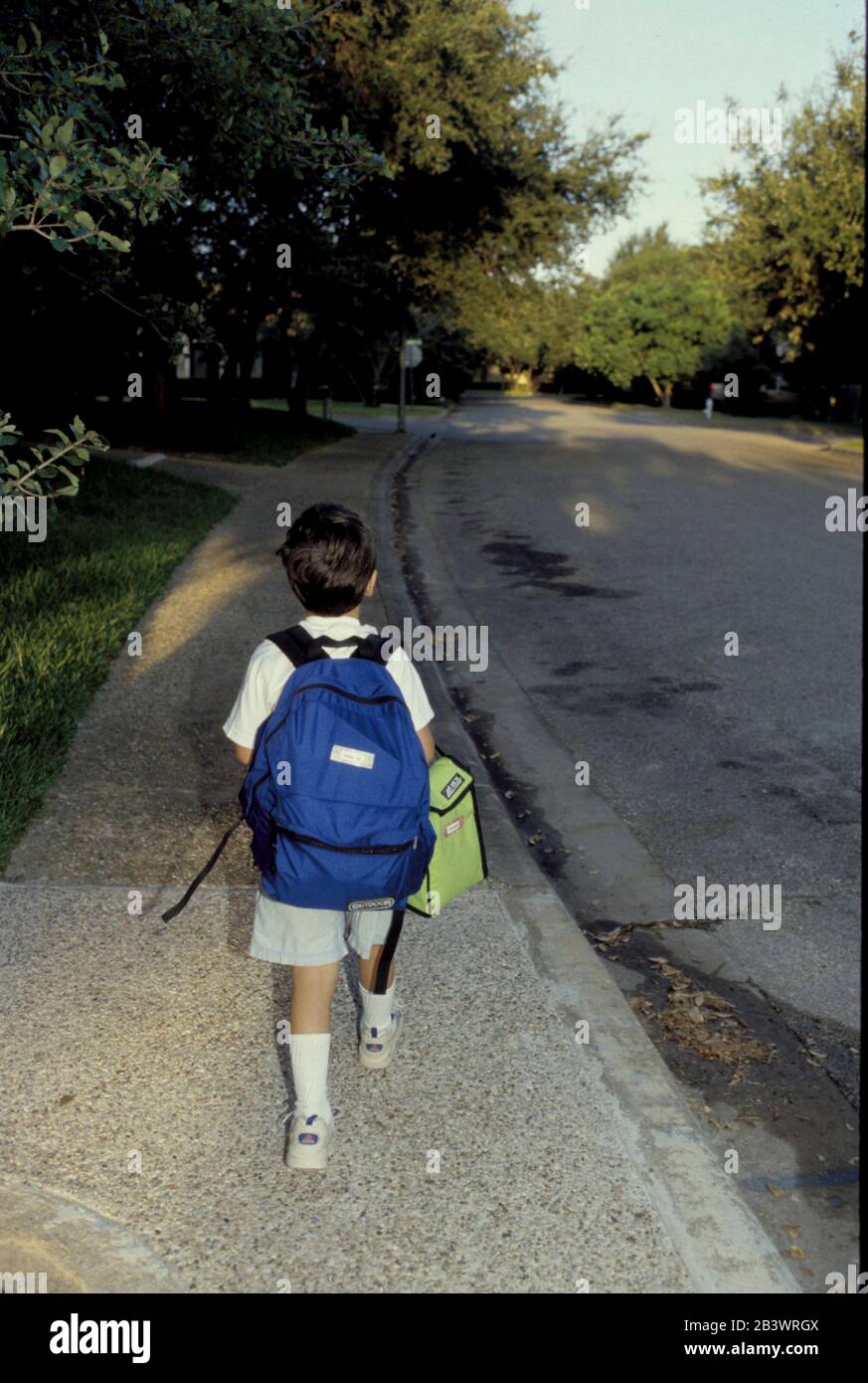 Austin Texas USA, 1999: Five-year-old boy walking to school during his ...