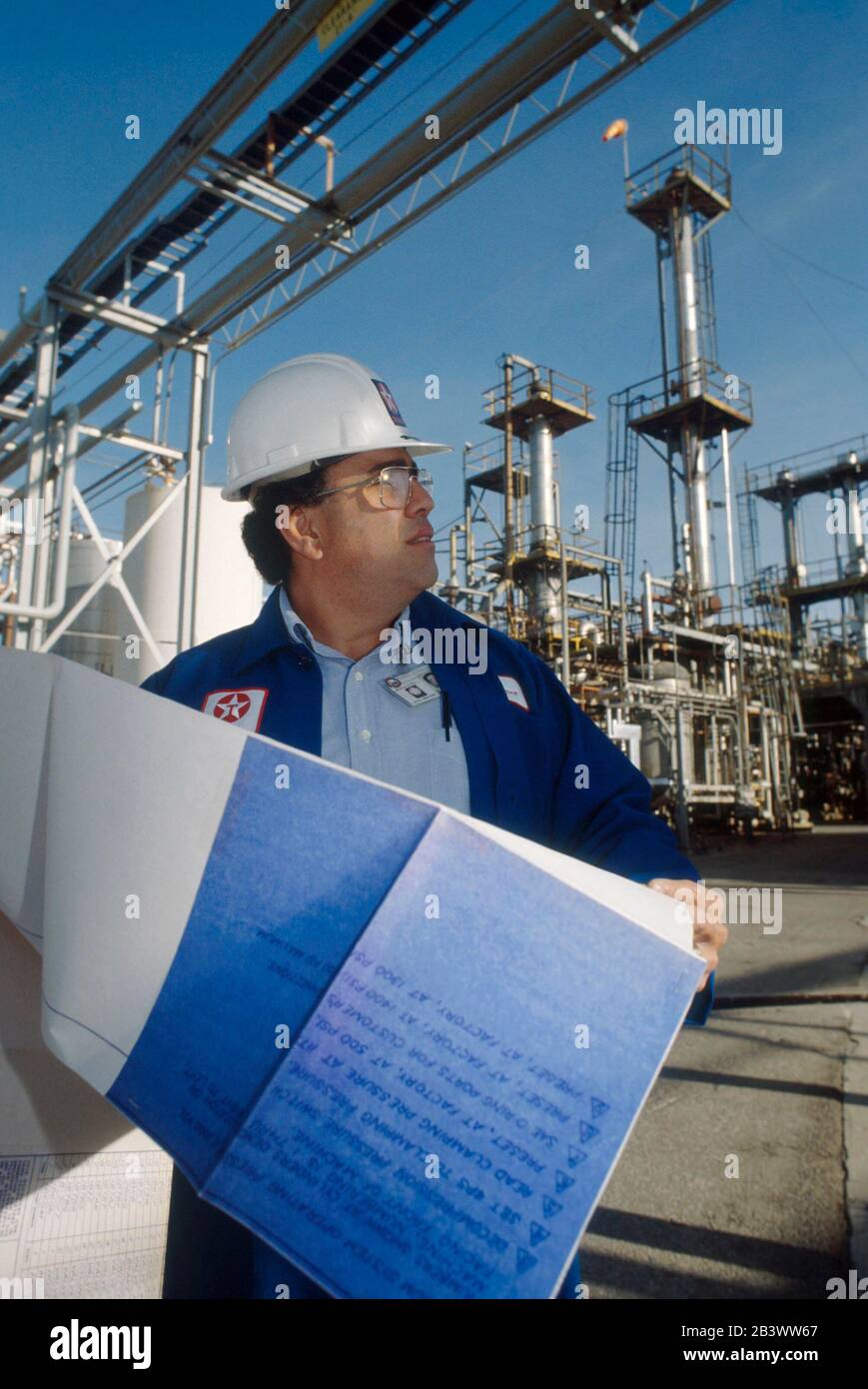 Austin Texas USA: Hispanic male chemical engineer looks over blueprints ...
