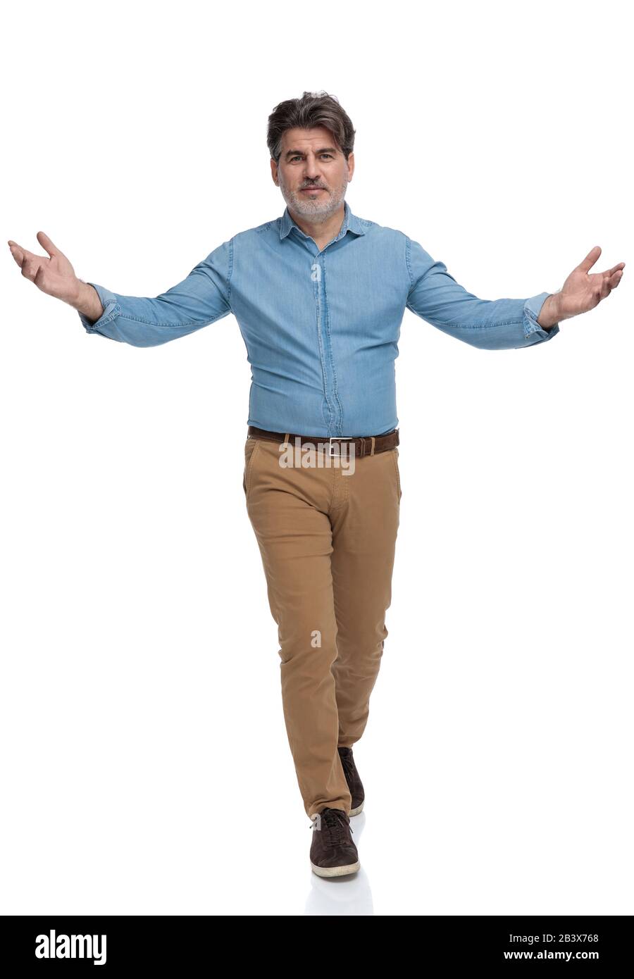 Confident casual man welcoming with his arms wide open while walking on ...
