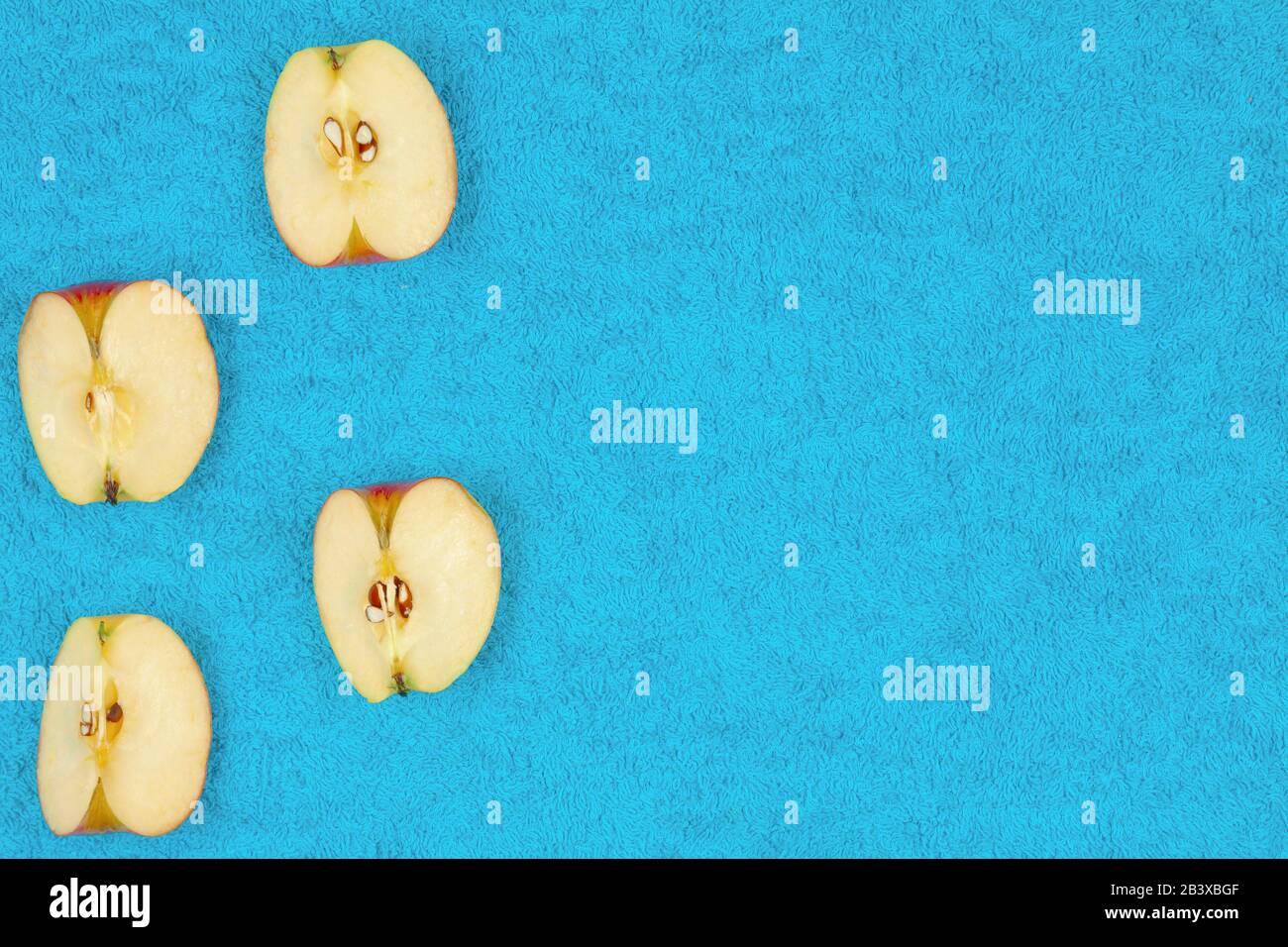Cut apples lie on a colored background Stock Photo - Alamy