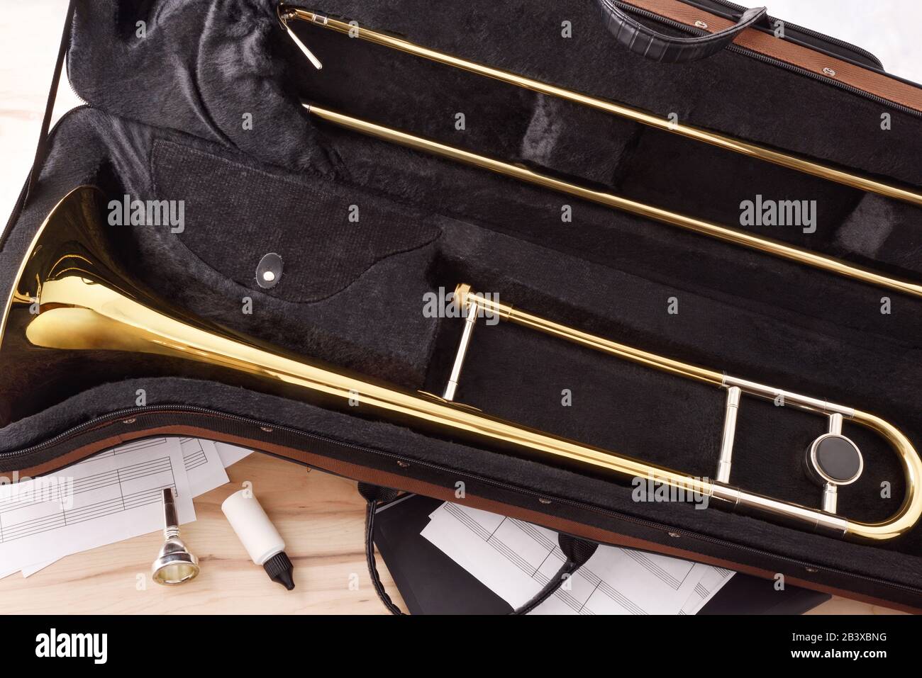 Student trombone and equipment on wooden table. Top view. Horizontal ...