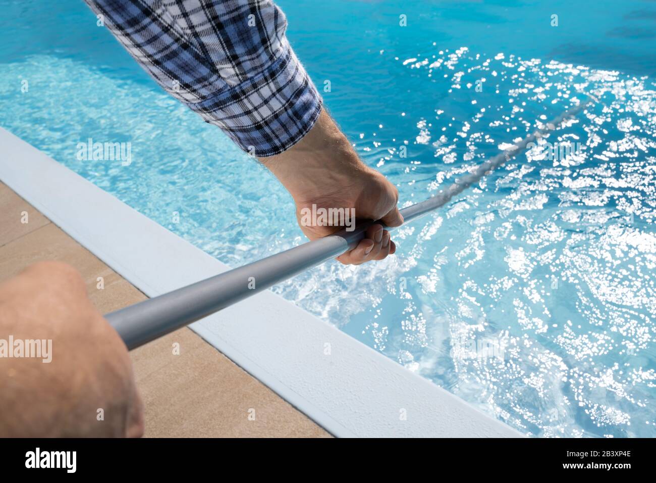 Male Worker In Uniform Cleaning Swimming Pool Stock Photo - Alamy