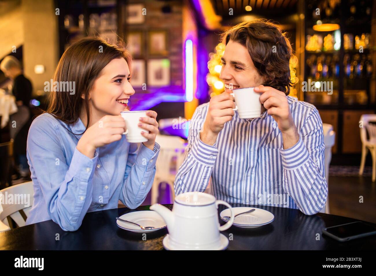 Cute couple having coffee together in cafe Stock Photo - Alamy