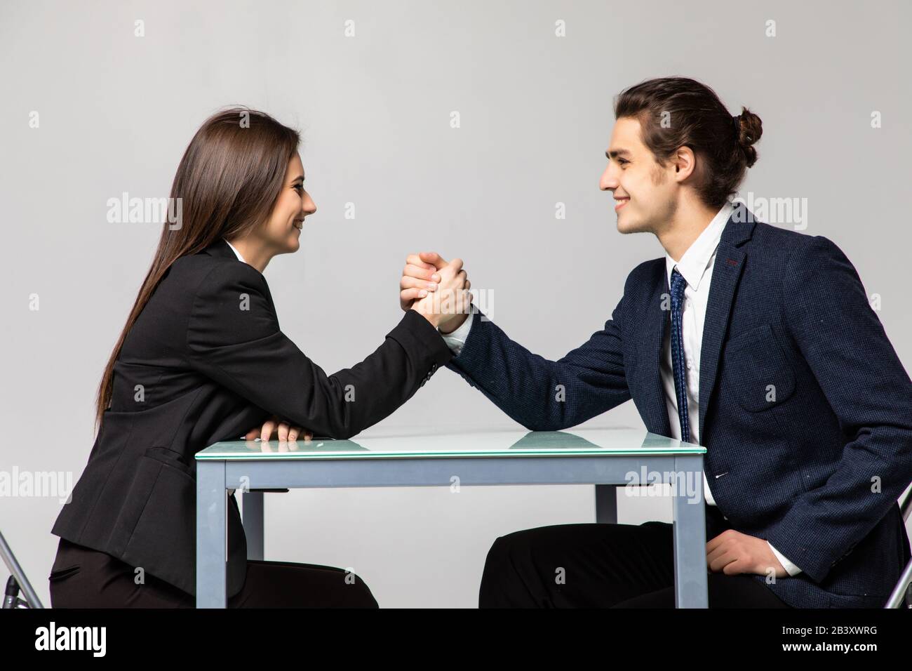 Beautiful couple doing arm wrestling challenge Stock Photo - Alamy