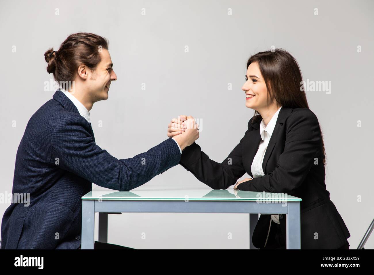 Beautiful couple doing arm wrestling challenge Stock Photo - Alamy