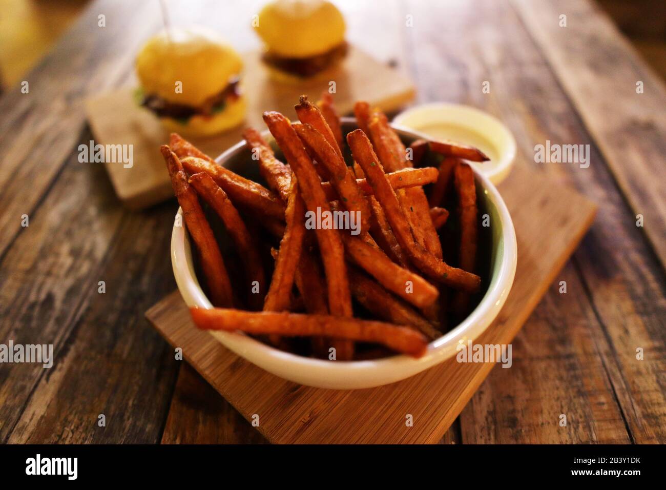 Title: Sweet potato fried chips in bowl on rustic wood tabletop Stock ...