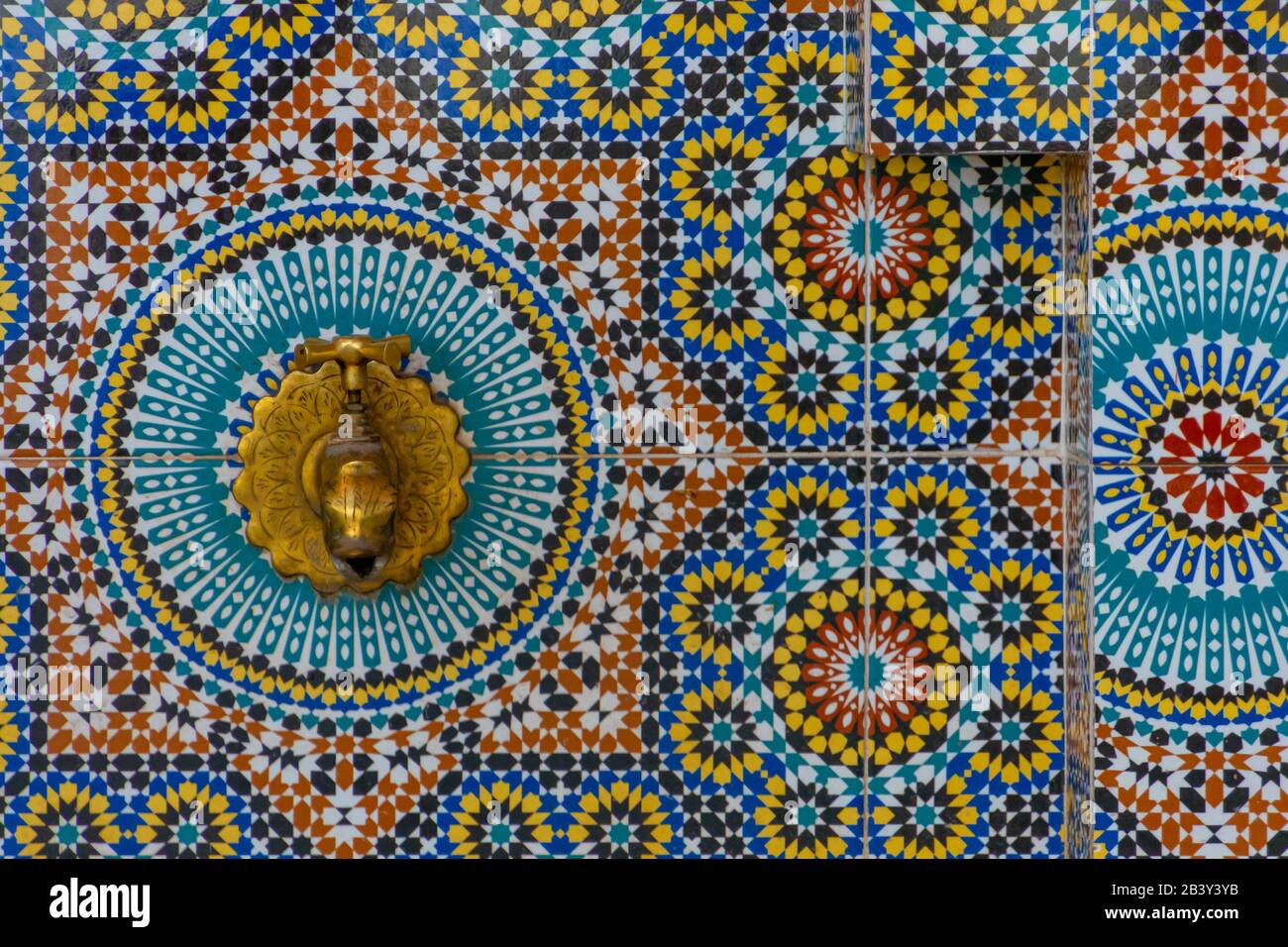 Colorful Arabic mosaic fountain and bronze tap Stock Photo - Alamy