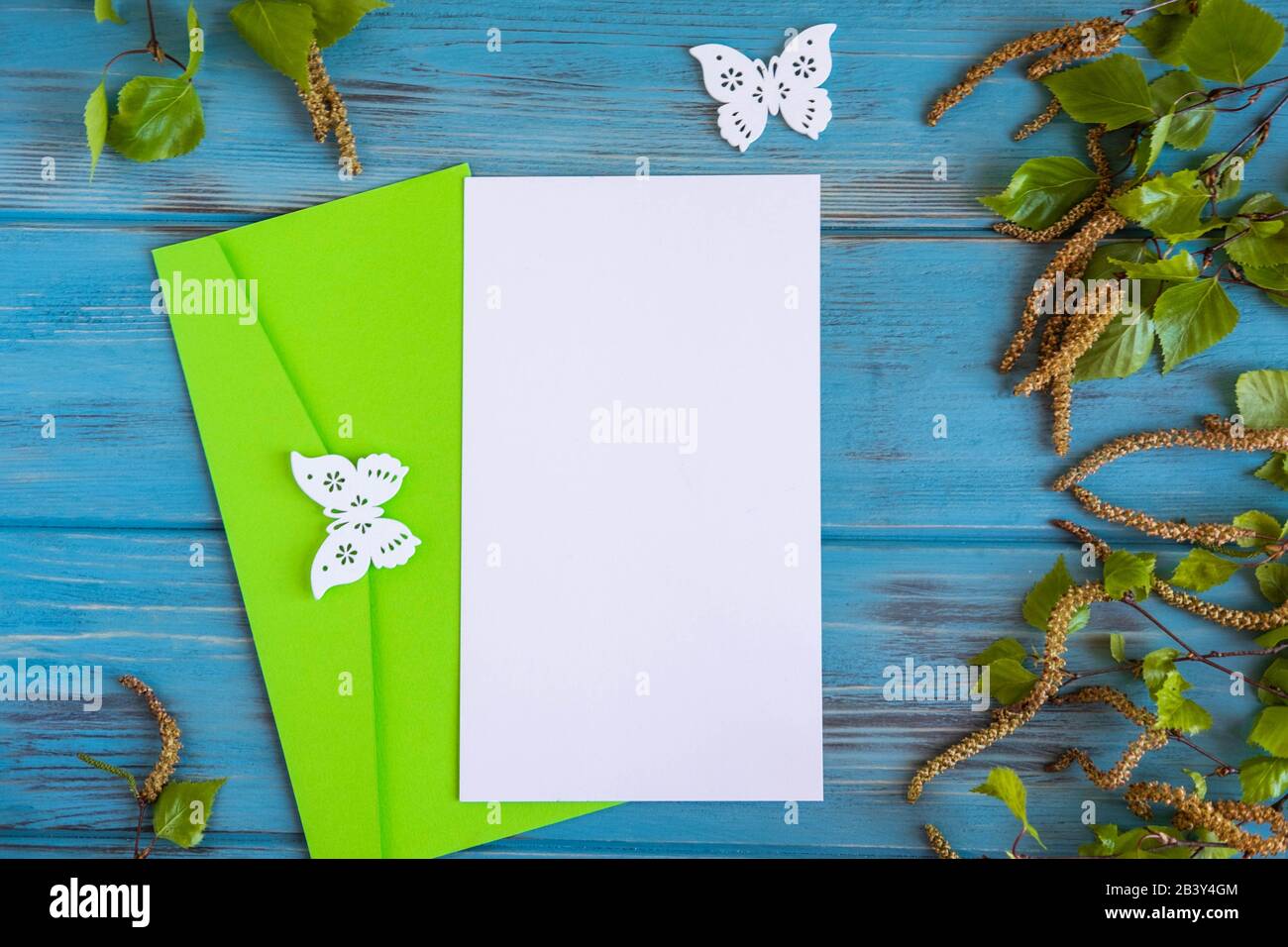 Mock up blank of a spring blank with birch branches on an aged blue ...