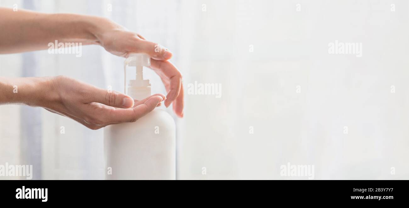 Woman hands pushing pump plastic soap bottle with copy space, using ...