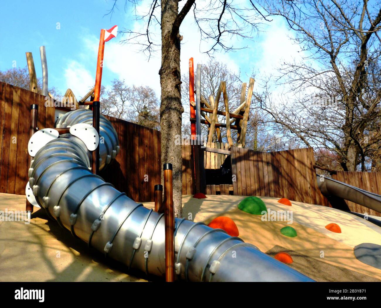 stainless steel tube slide. public park. colorful orange, yellow and ...