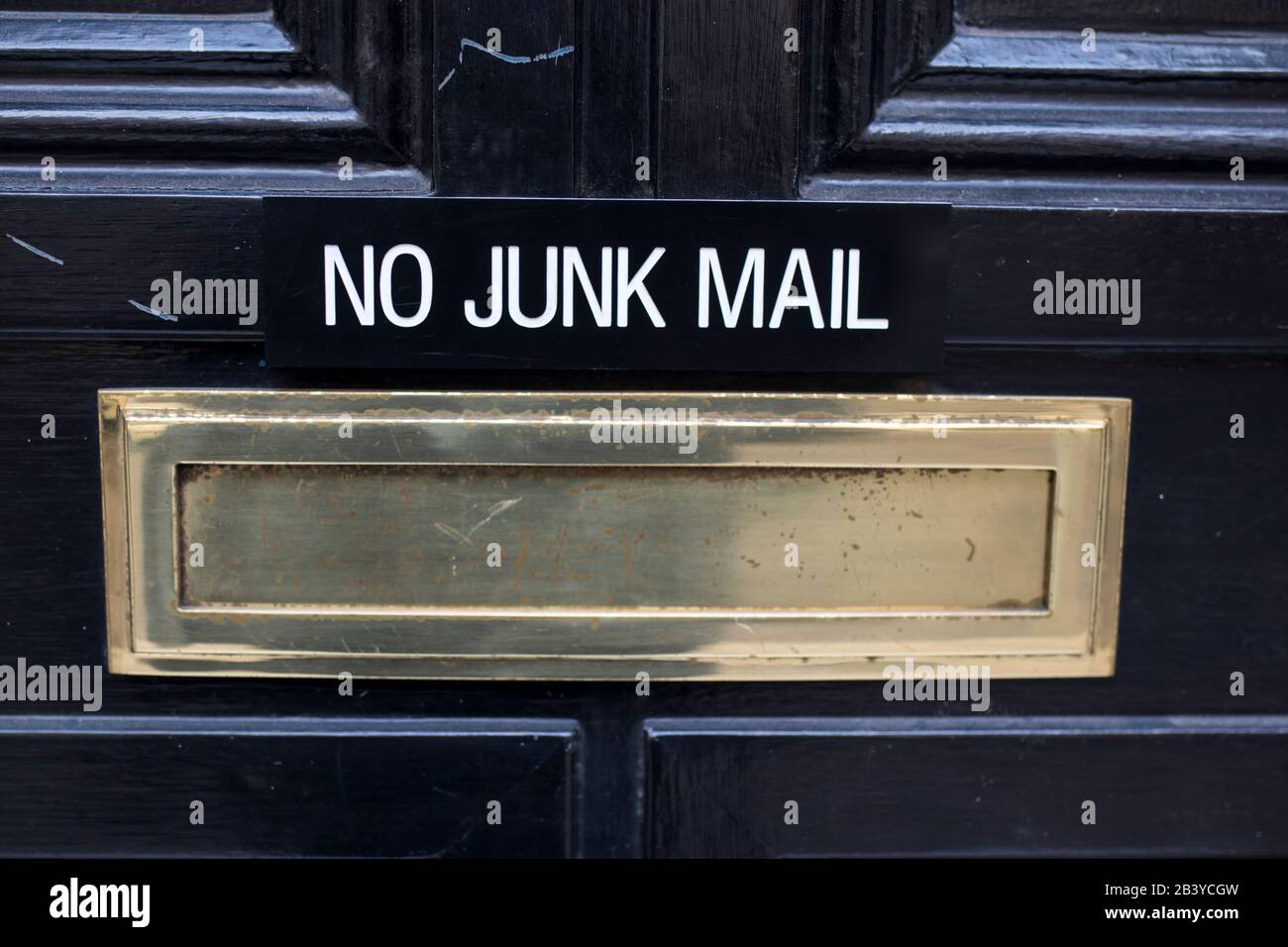 House letterbox with 'No junk mail' sign and junk mail Stock Photo - Alamy