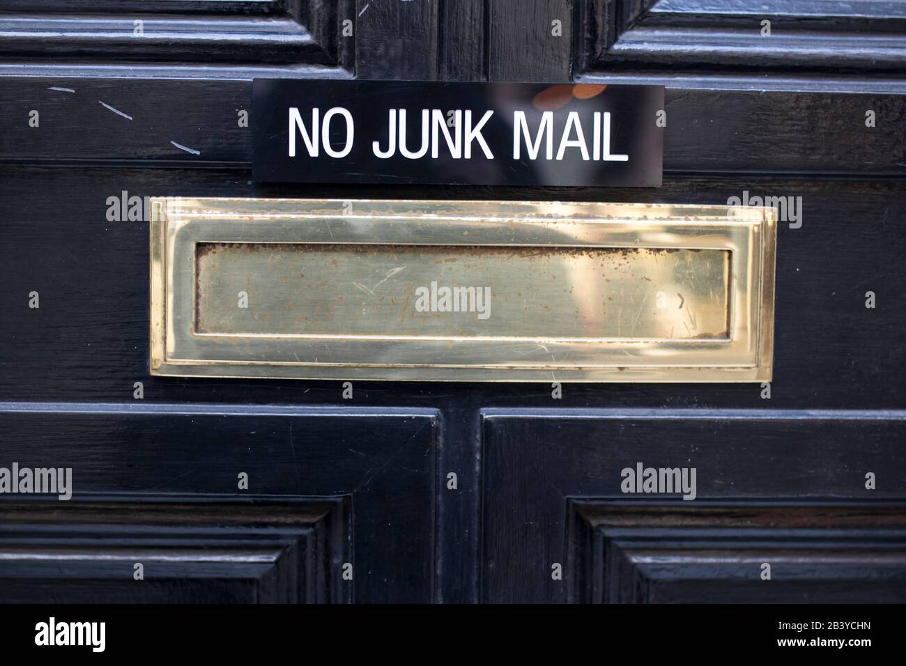 House letterbox with 'No junk mail' sign and junk mail Stock Photo - Alamy