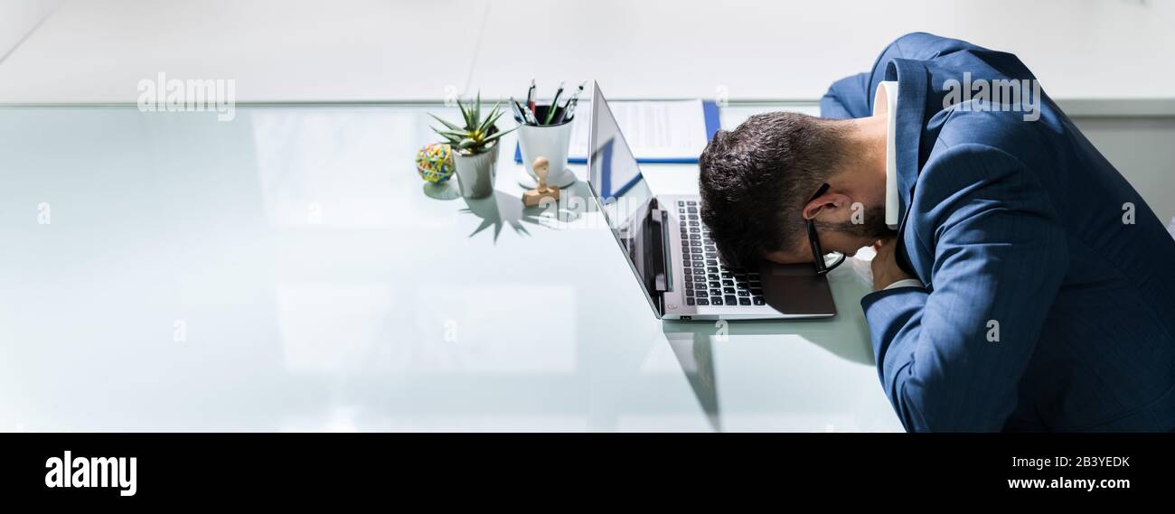 Mature Businessman Sleeping With Computer At Desk In Office Stock Photo ...