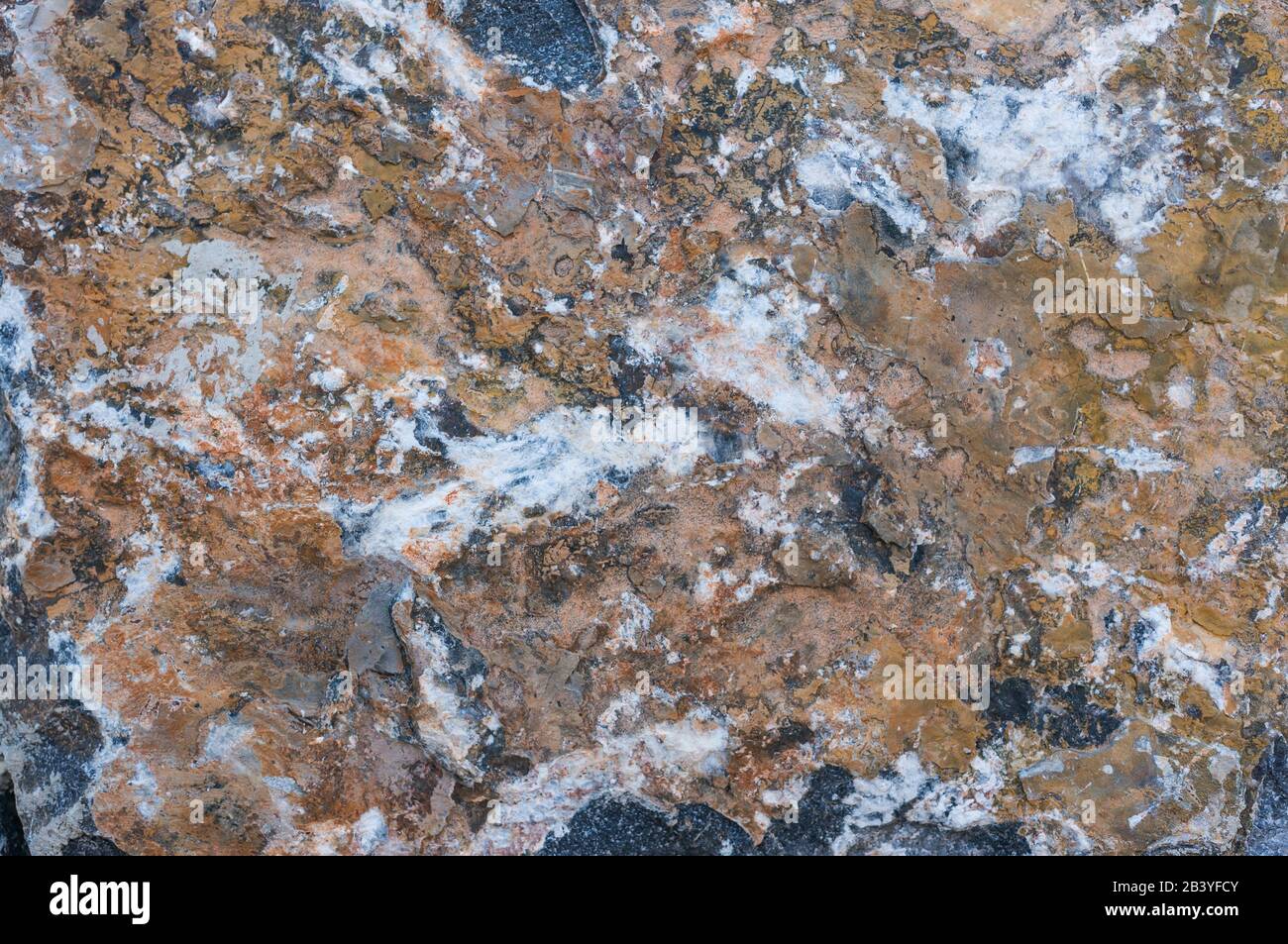 Gray granite texture of the wall with brown paint and peeling plaster ...