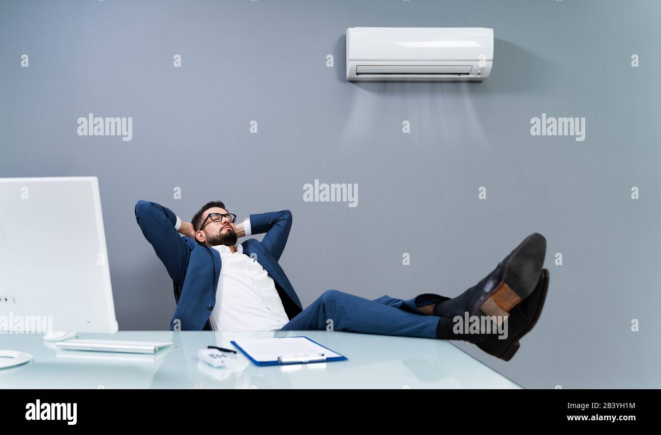 Relaxed Businessman Enjoying The Cooling Of Air Conditioner In The ...