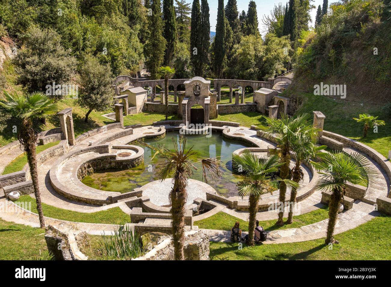GARDONE RIVIERA, LAKE GARDA, ITALY - SEPTEMBER 2018: Water feature with palm trees in the ...