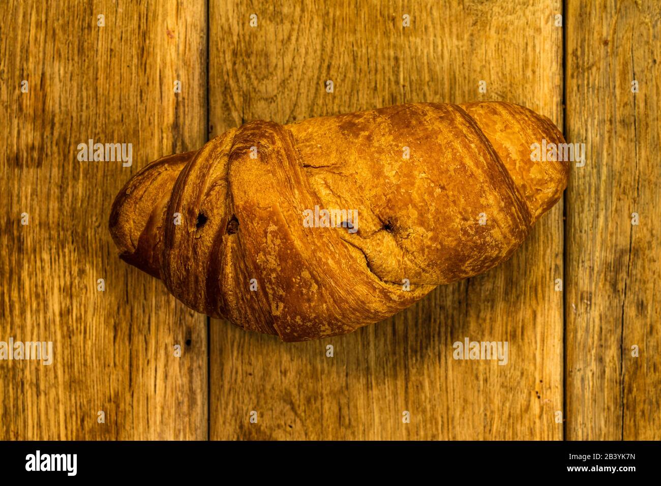 Fresh croissant on wooden table. Chocolate croissant on the table ...