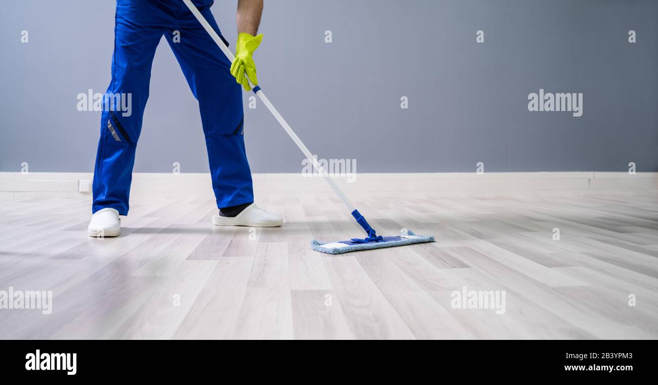 Worker Mopping Floor With Mop In Office Stock Photo - Alamy