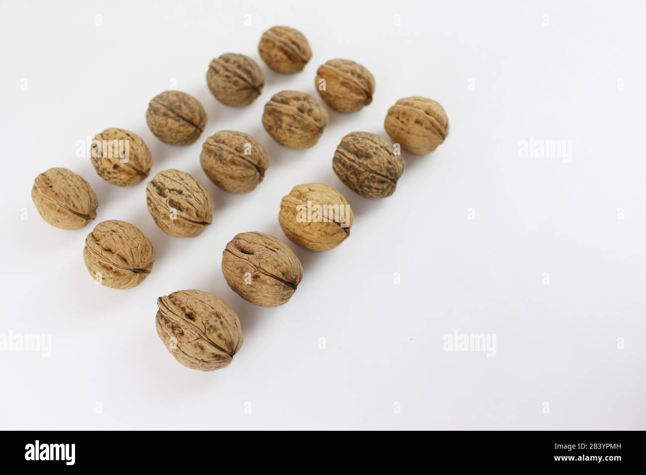 Group of nuts, dried fruit, positioned in parallel lines, with a ...