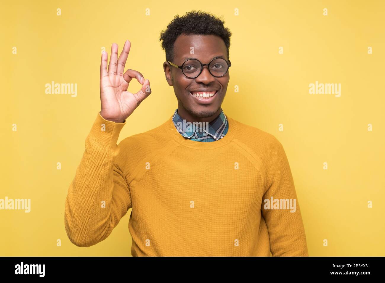 Happy african american black man showing ok sign and smiling, over ...