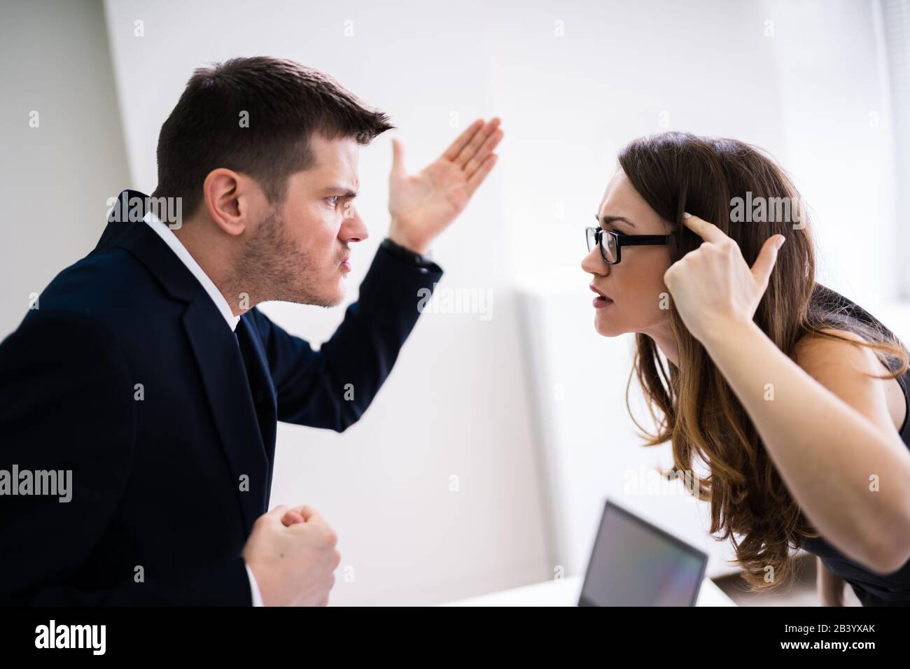 Side View Of Business People Quarreling At Desk In Office Stock Photo ...