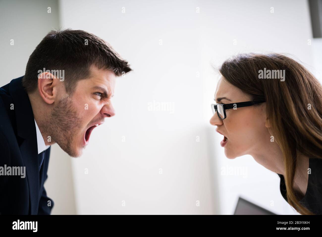 Side View Of Business People Quarreling At Desk In Office Stock Photo ...