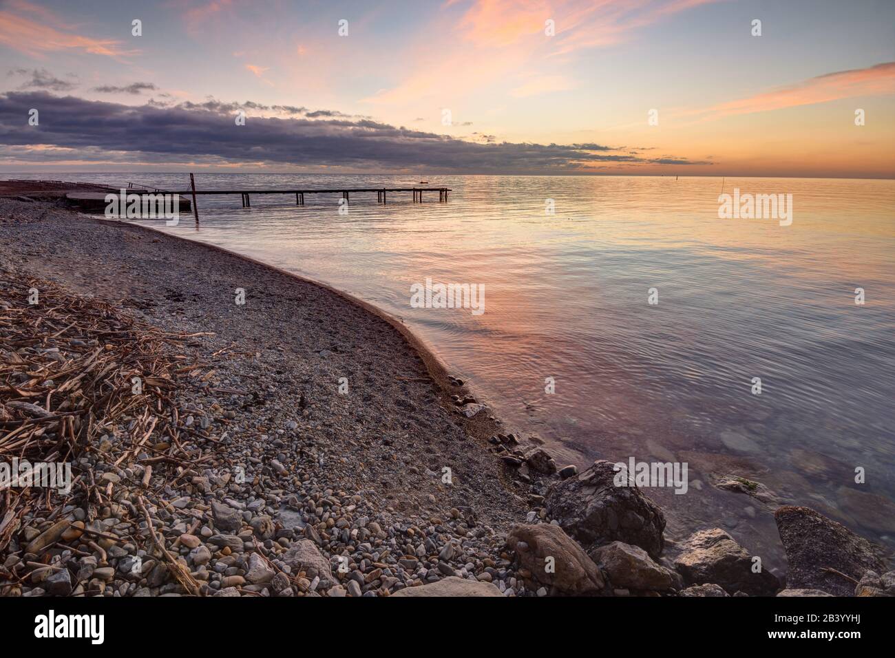 Beautiful evening sunset at sea, at the far end of the pier Stock Photo ...