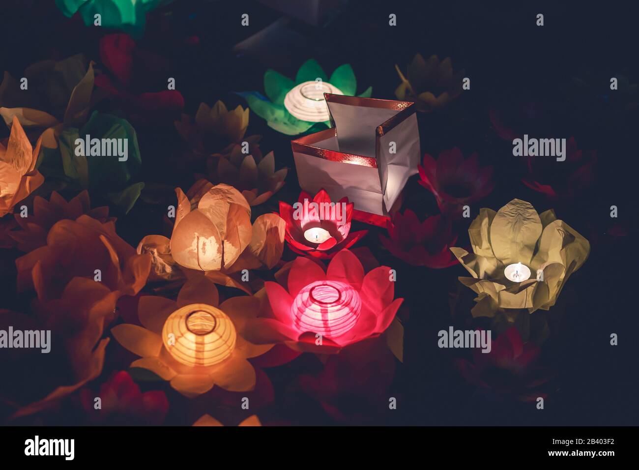 Beautiful Multicolored floating lanterns in the water in Chinese or ...