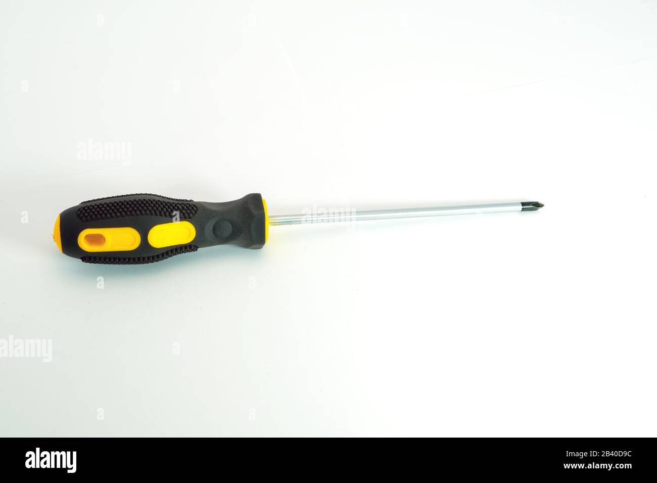Close-up photo of black and yellow screwdriver on the white background ...