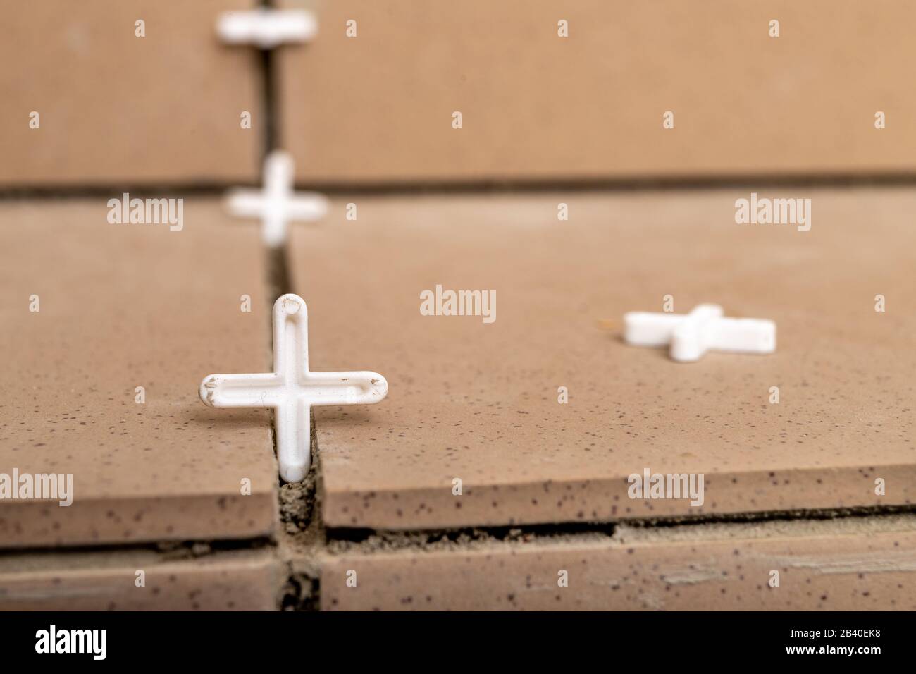 Plastic crosses that position the tiles when laying. The process of ...