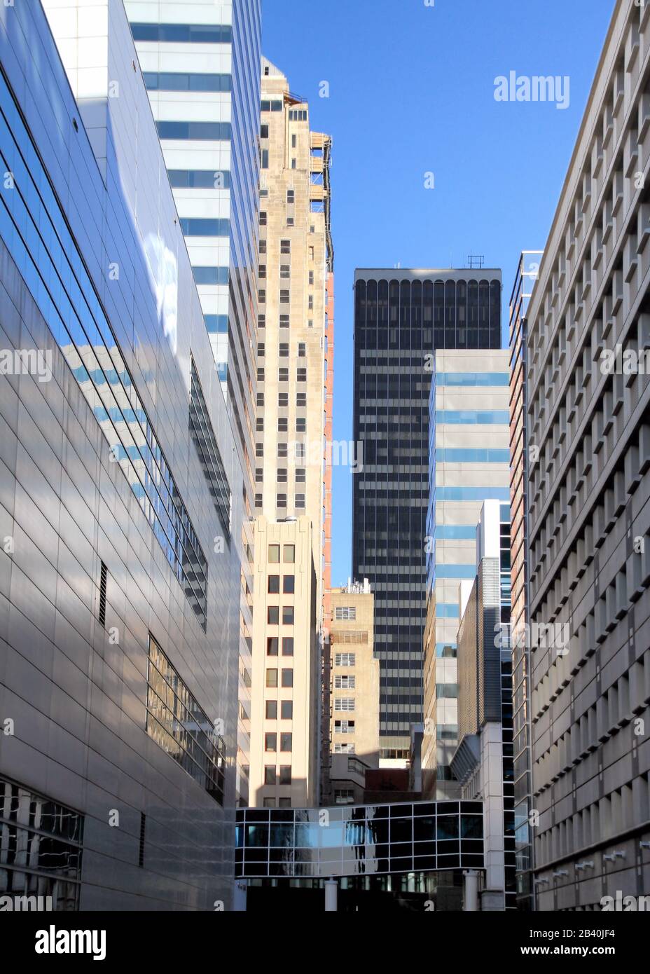 A vertical view of an alley surrounded by skyscrapers in downtown ...