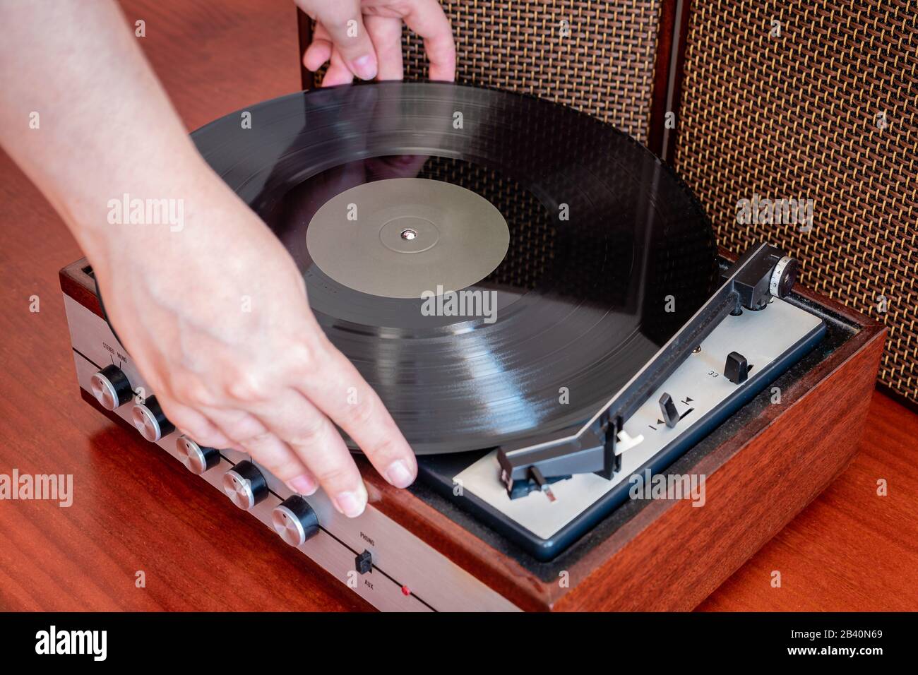 Hands put a vinyl on an old wooden turntable Stock Photo - Alamy