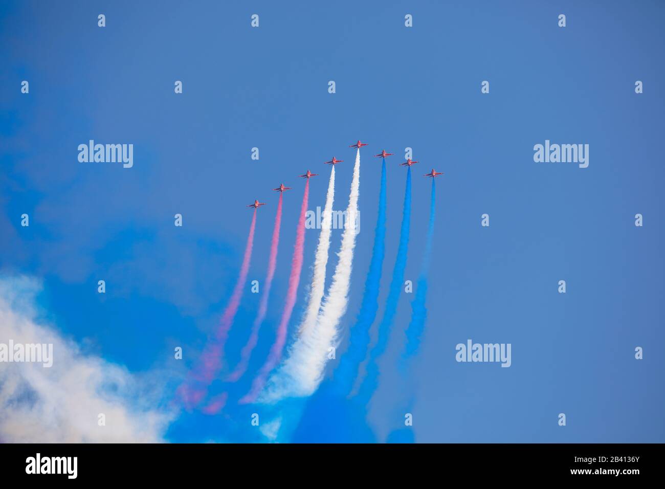 Aerobatic plane with colorful americcan flag smoke in the blue sky ...
