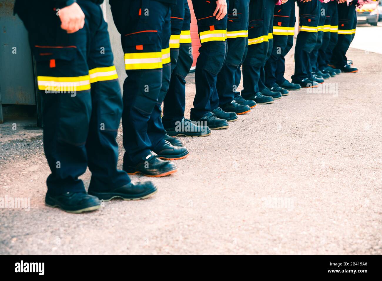 Group of firefighters doing teamwork dressed in their work uniforms ...