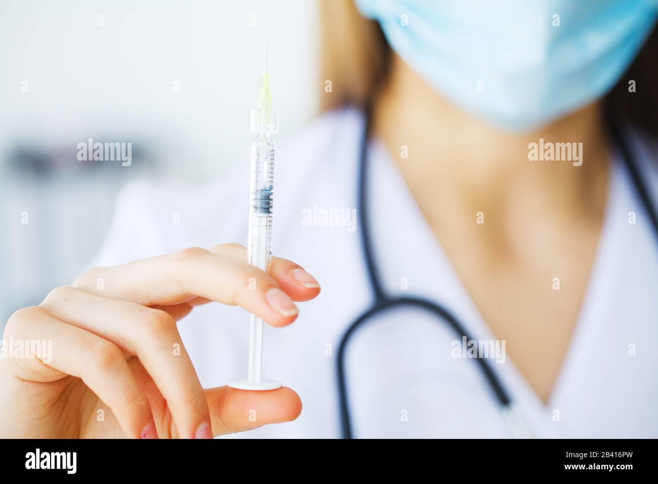 Woman doctor shaking in hands a syringe full Stock Photo - Alamy