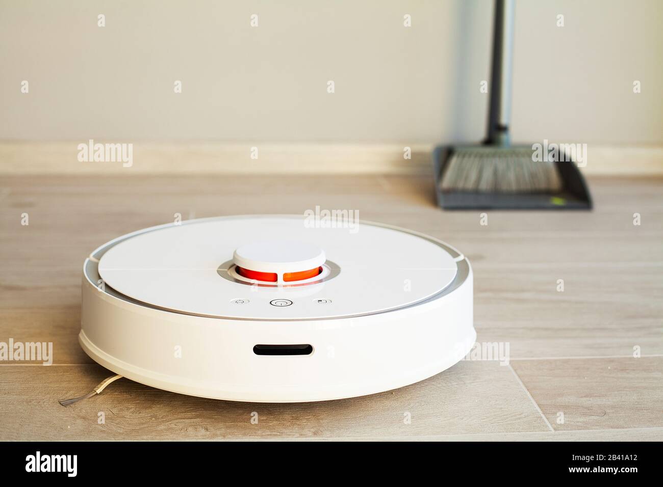 Comparison of Robot Cleaner and Broom in Bright Room Stock Photo - Alamy