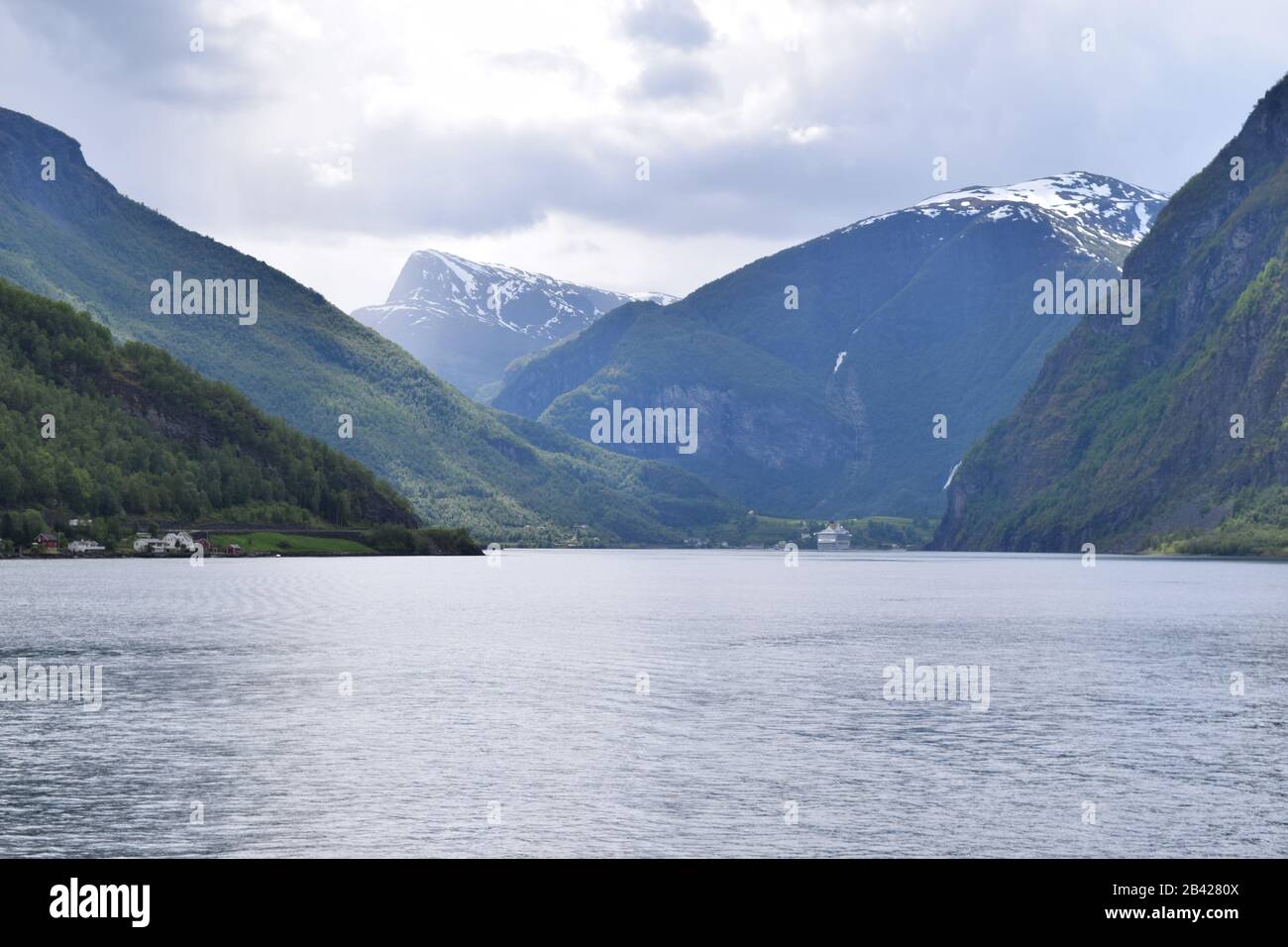Norwegian fjord view from a Scandinavian cruise ship. Clam water with ...